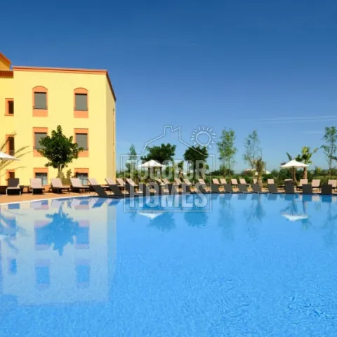 Which 2-bedroom apartments offer access to communal pools in Vilamoura ...